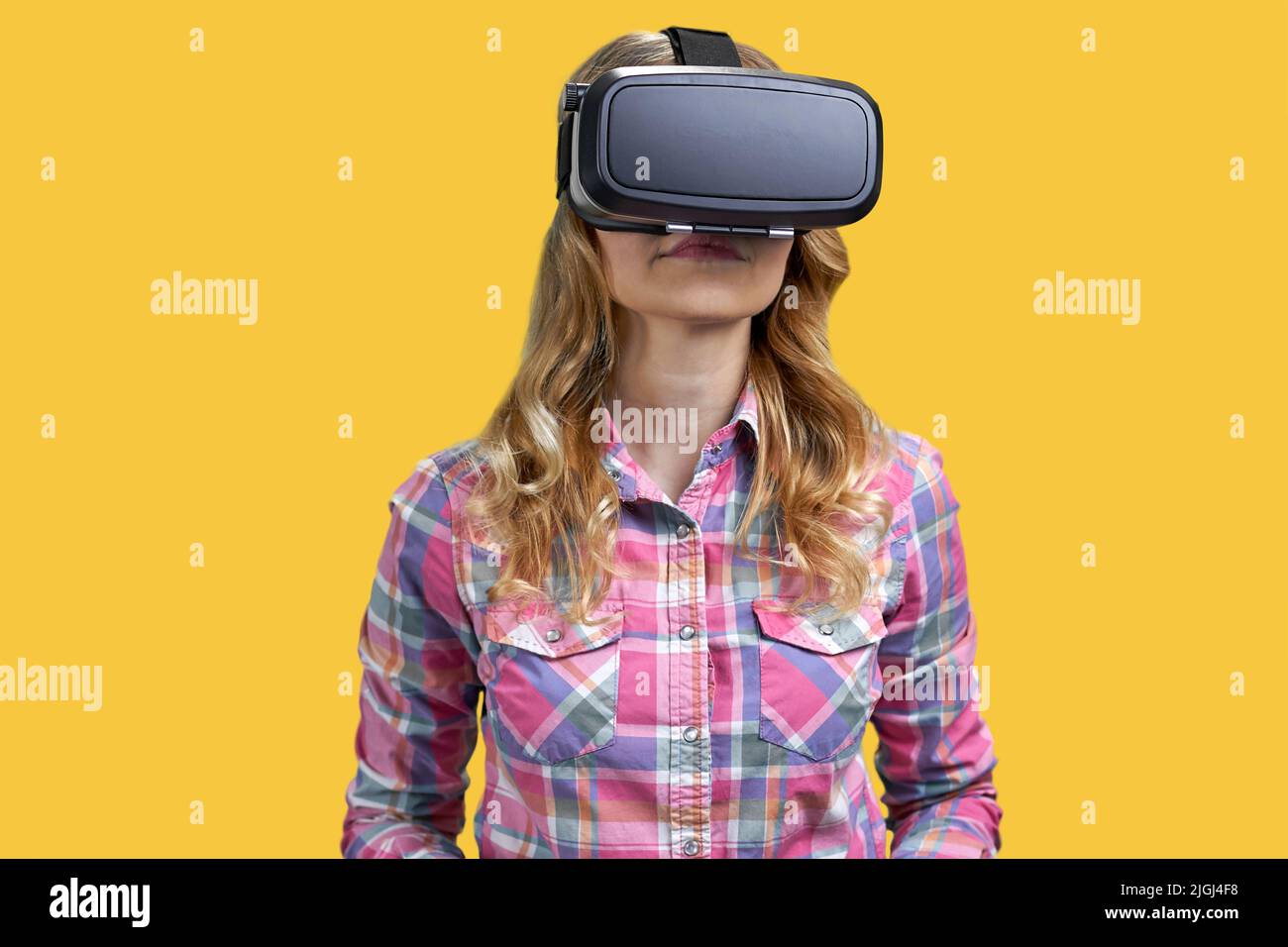 Young woman wearing virtual reality glasses on color background. Future ...