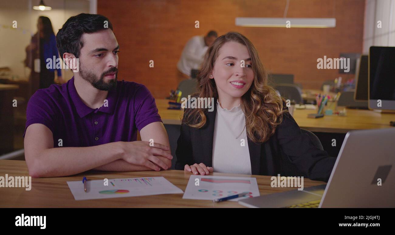 Female staff coaching new male employee at new job. First day work ...