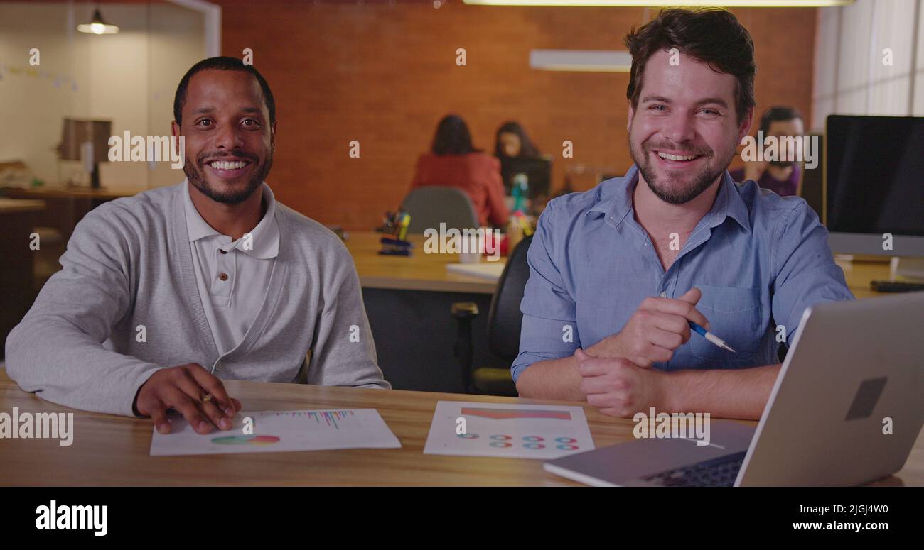 Portraits of two diverse colleagues smiling at camera. Male and female ...