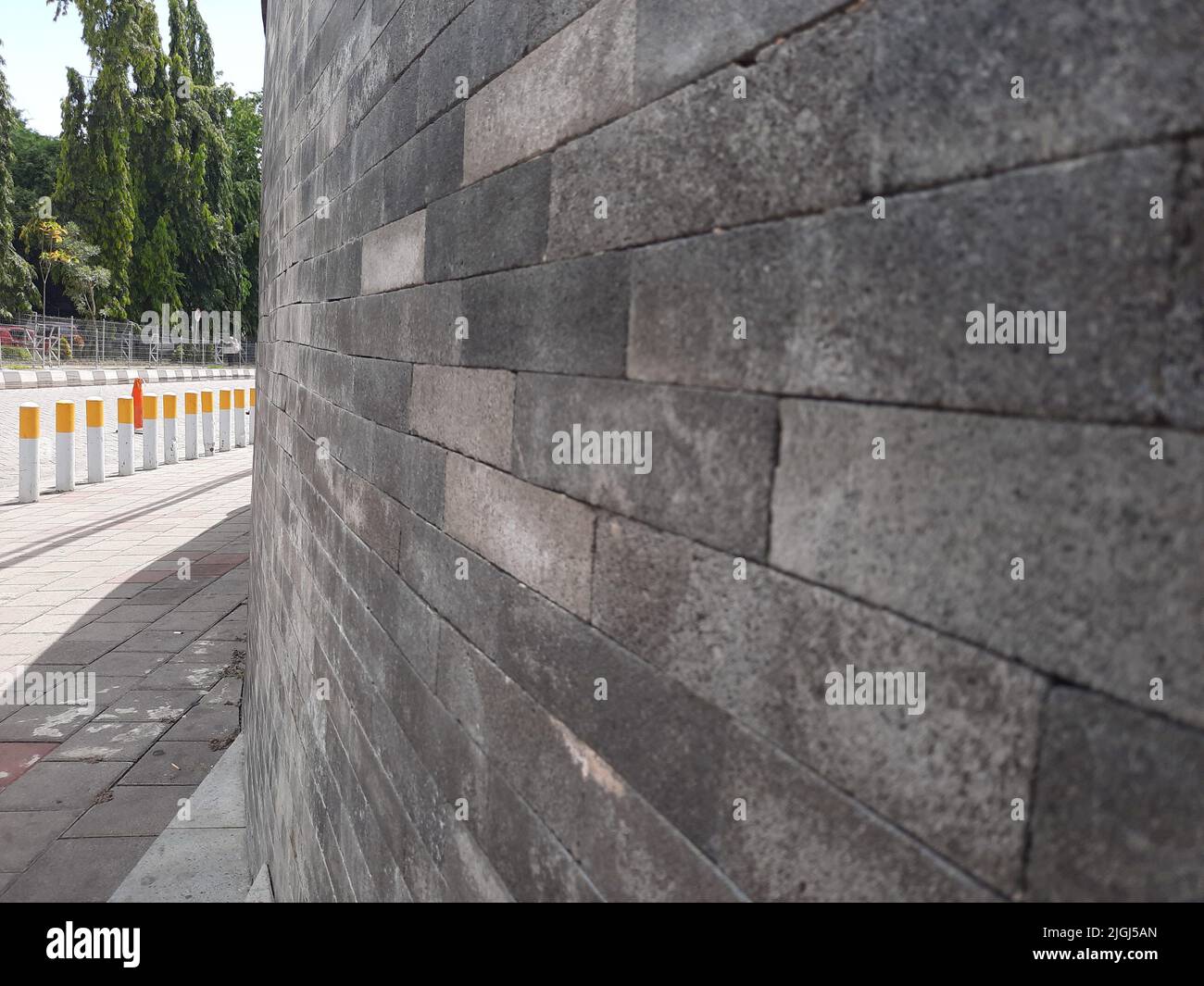 Closeup from a grey brick wall with selective focus for backgrounds ...