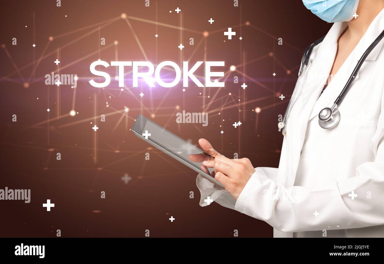 Doctor fills out medical record Stock Photo - Alamy