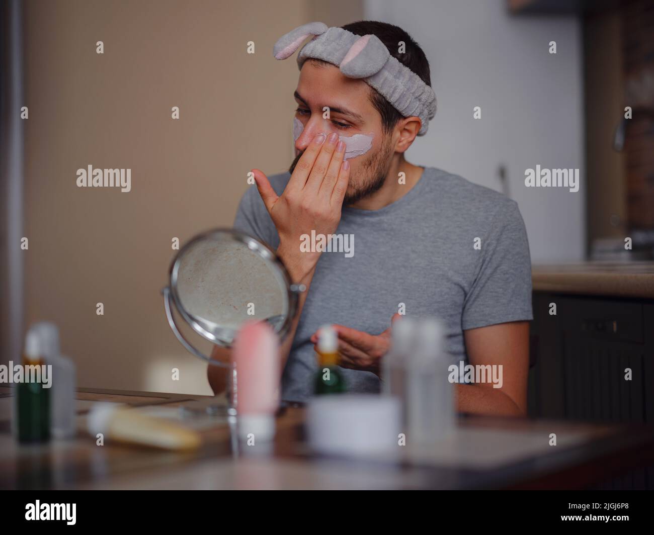 Men's beauty concept. caucAsian guy checking his skin. man looking into ...