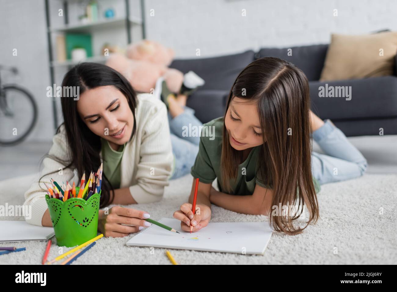 Smiling nanny girl drawing hi-res stock photography and images - Alamy