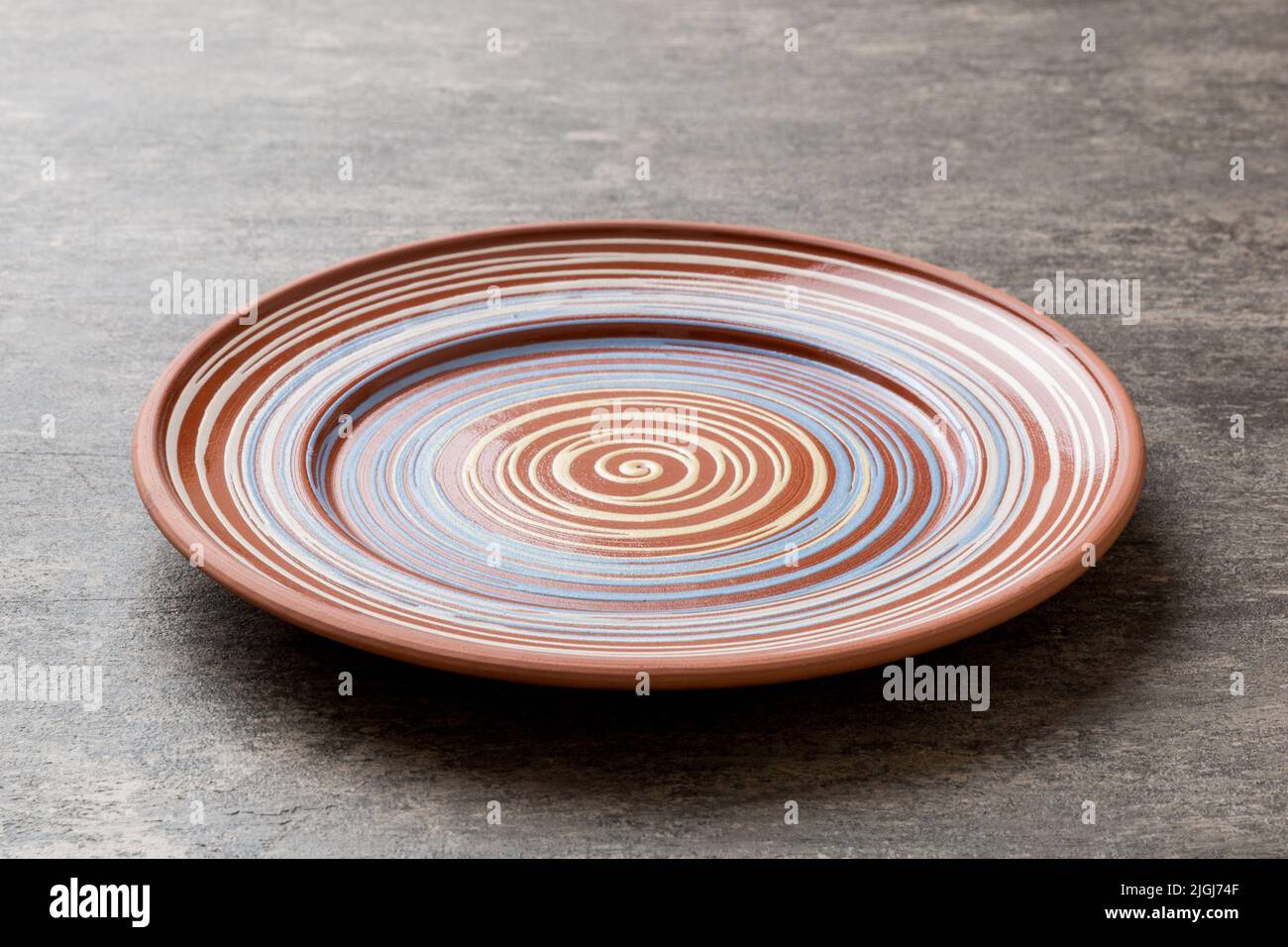 Perspective view of empty colorful plate on cement background. Empty ...
