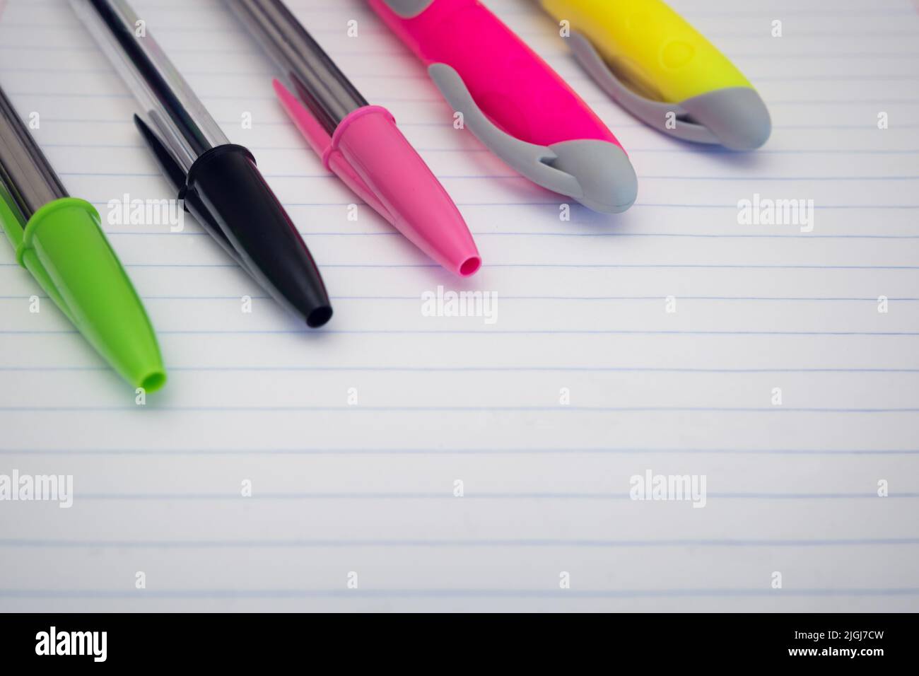 Close-up of colorful pens and fluorescent highlighters resting on a ...