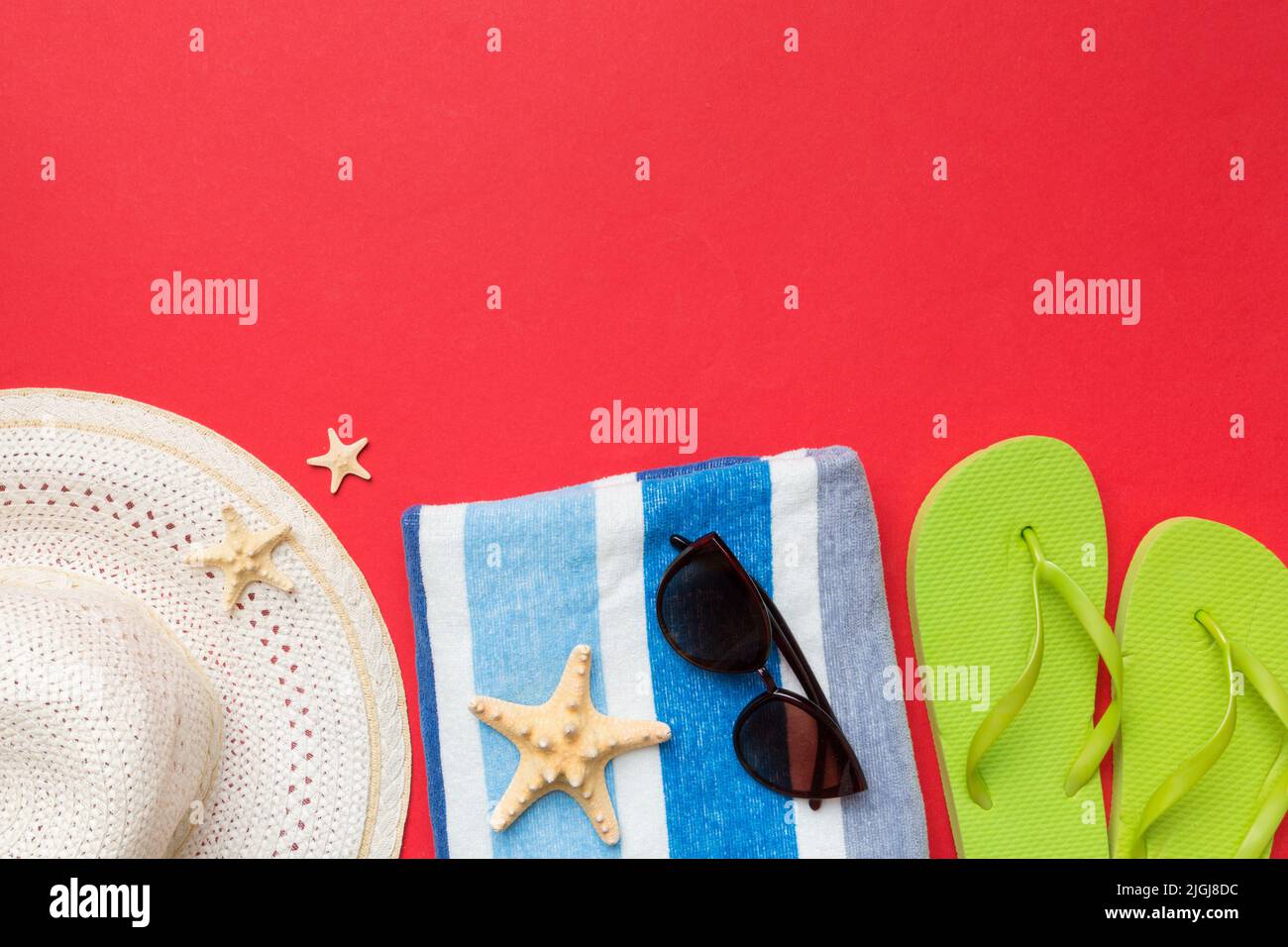 Summer vacation concept flat lay. straw hat beach accessories and towel ...