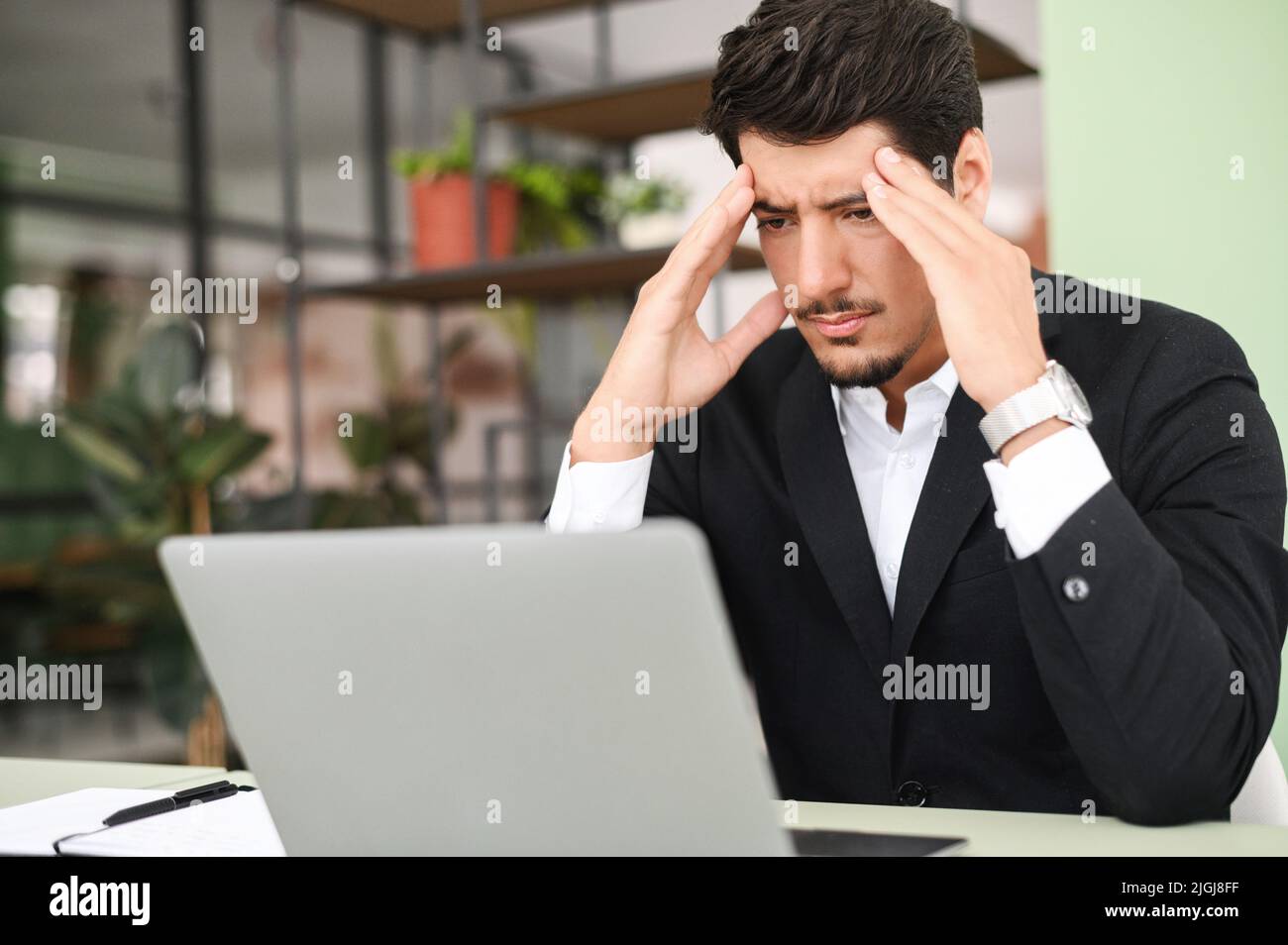 Fatigued hispanic businessman using laptop for working, the guy tired ... Fatigued hispanic businessman using laptop for working, the guy tired ...