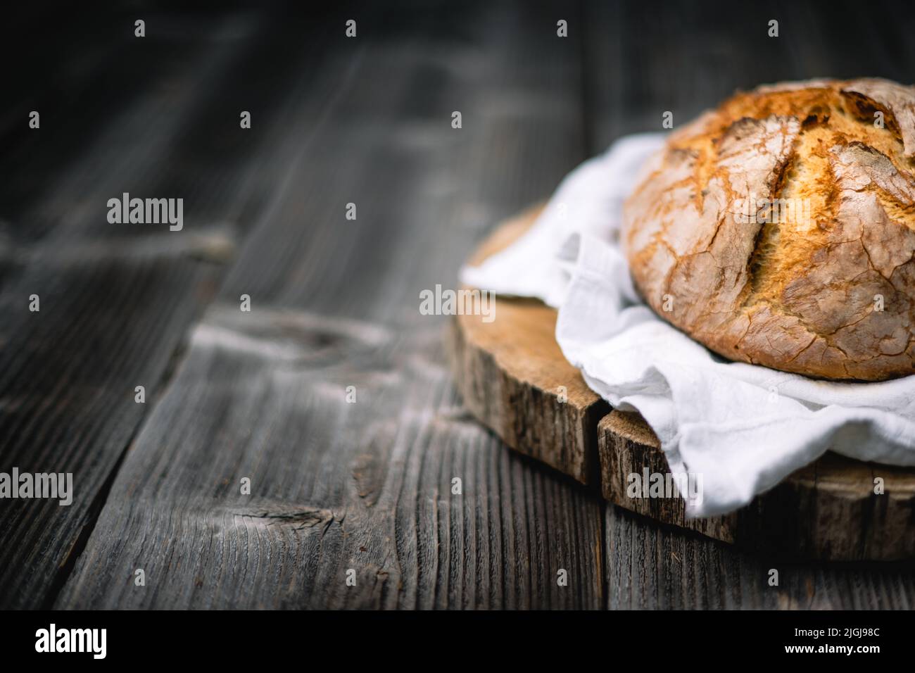 Traditional leavened sourdough bread with rought skin on a rustic ...