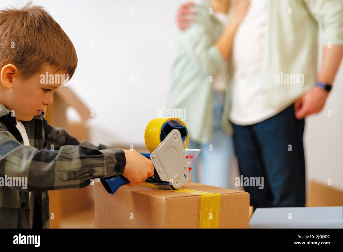 Little boy packing a moving box for a new home Stock Photo - Alamy