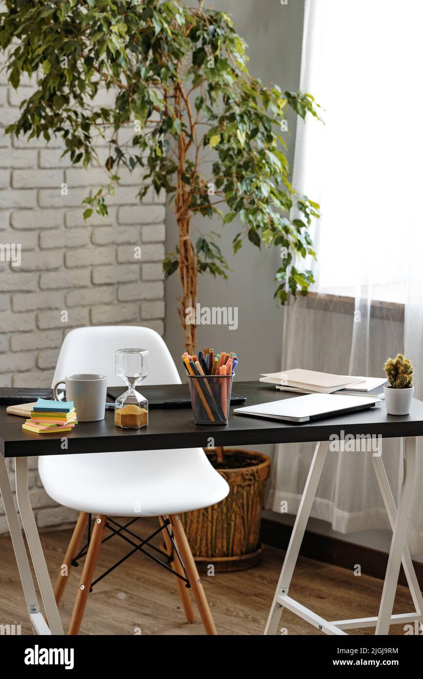Office desk with stationery items and laptop Stock Photo - Alamy