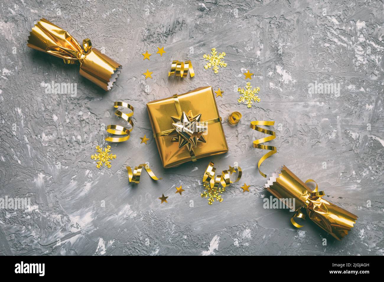 Christmas crackers with shiny confetti on color background, top view ...