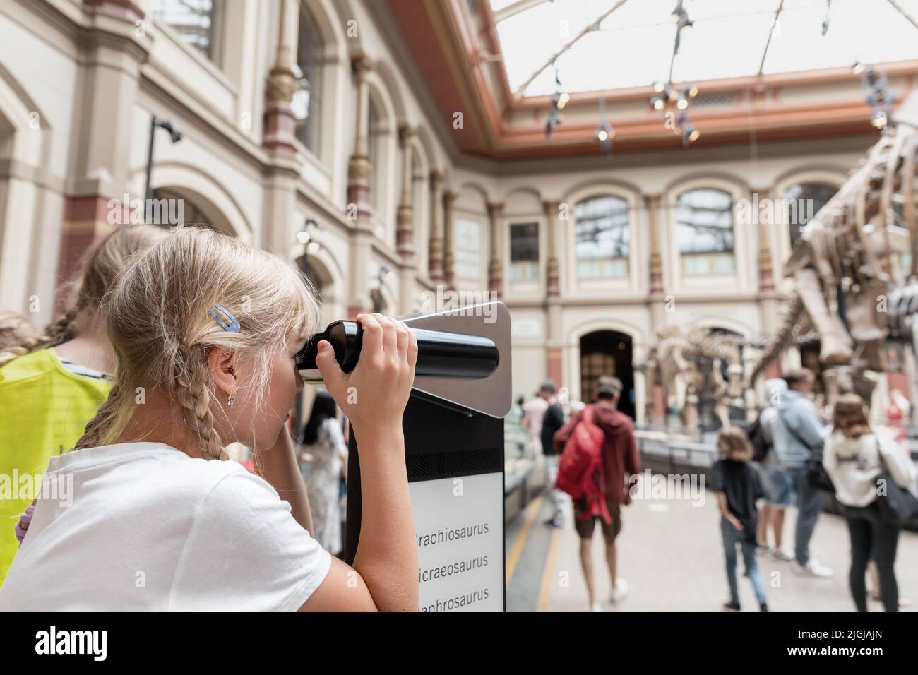 Cute little adorable curious blond kid girl watching AR reality ...