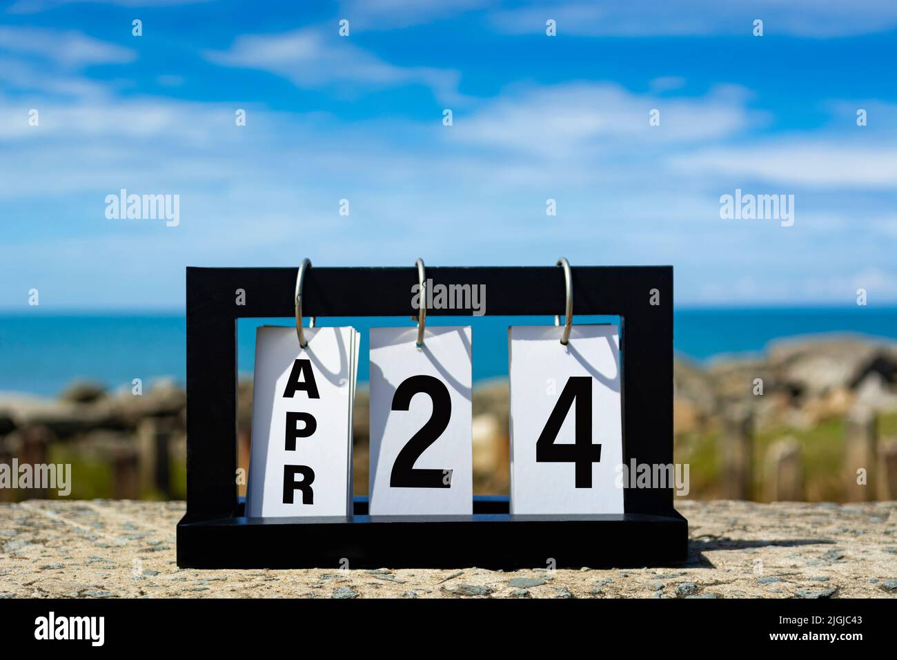 Apr 24 calendar date text on wooden frame with blurred background of ...
