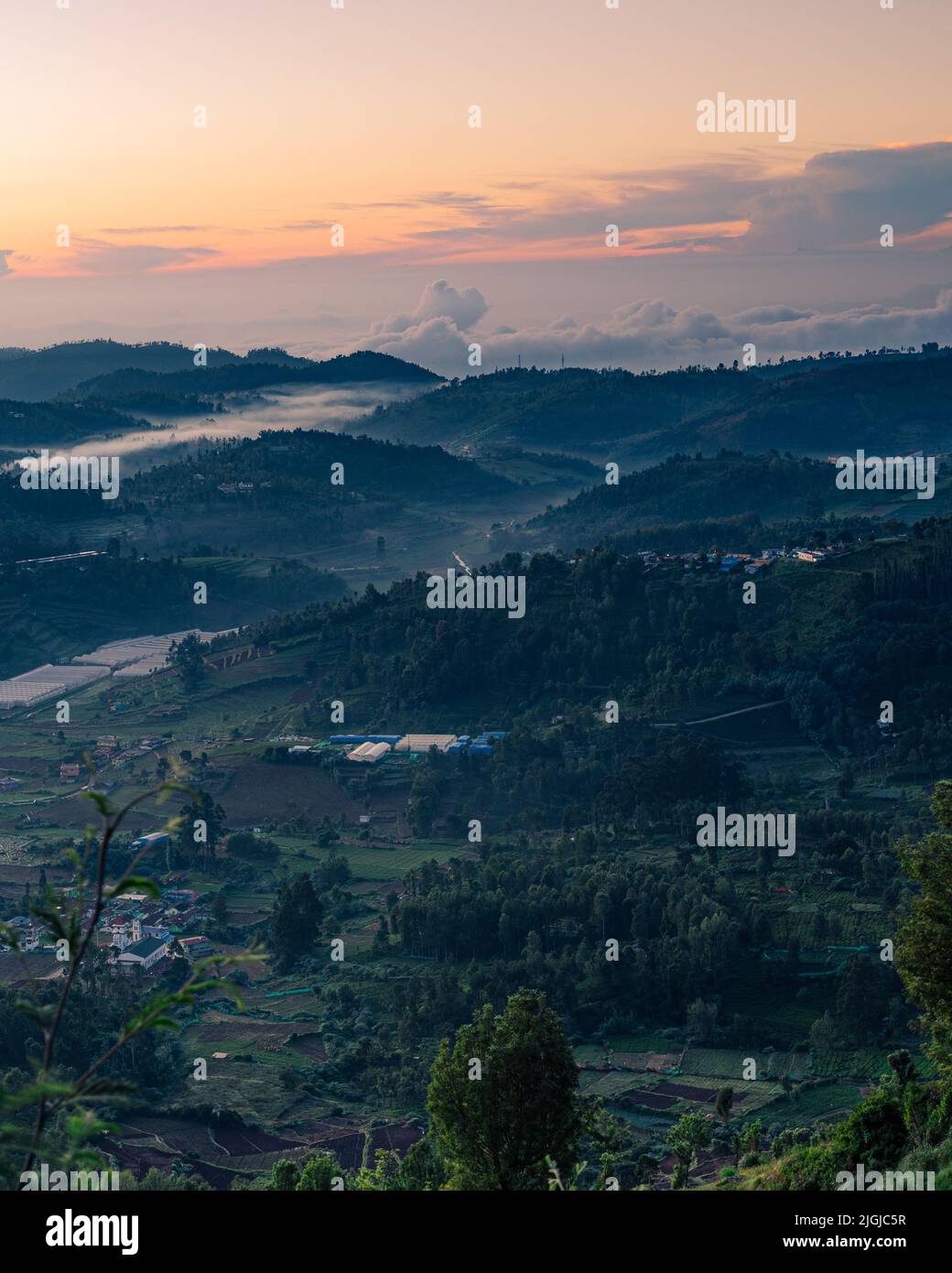Morning sunrise view of the hills in Ooty with blue tinted landscape ...