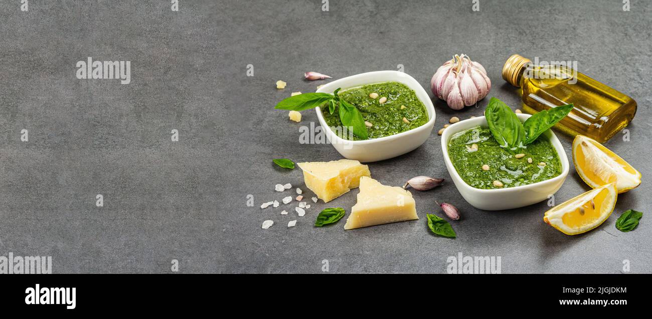 Pesto sauce in a bowls with pine nuts, parmesan and garlic. Traditional ...