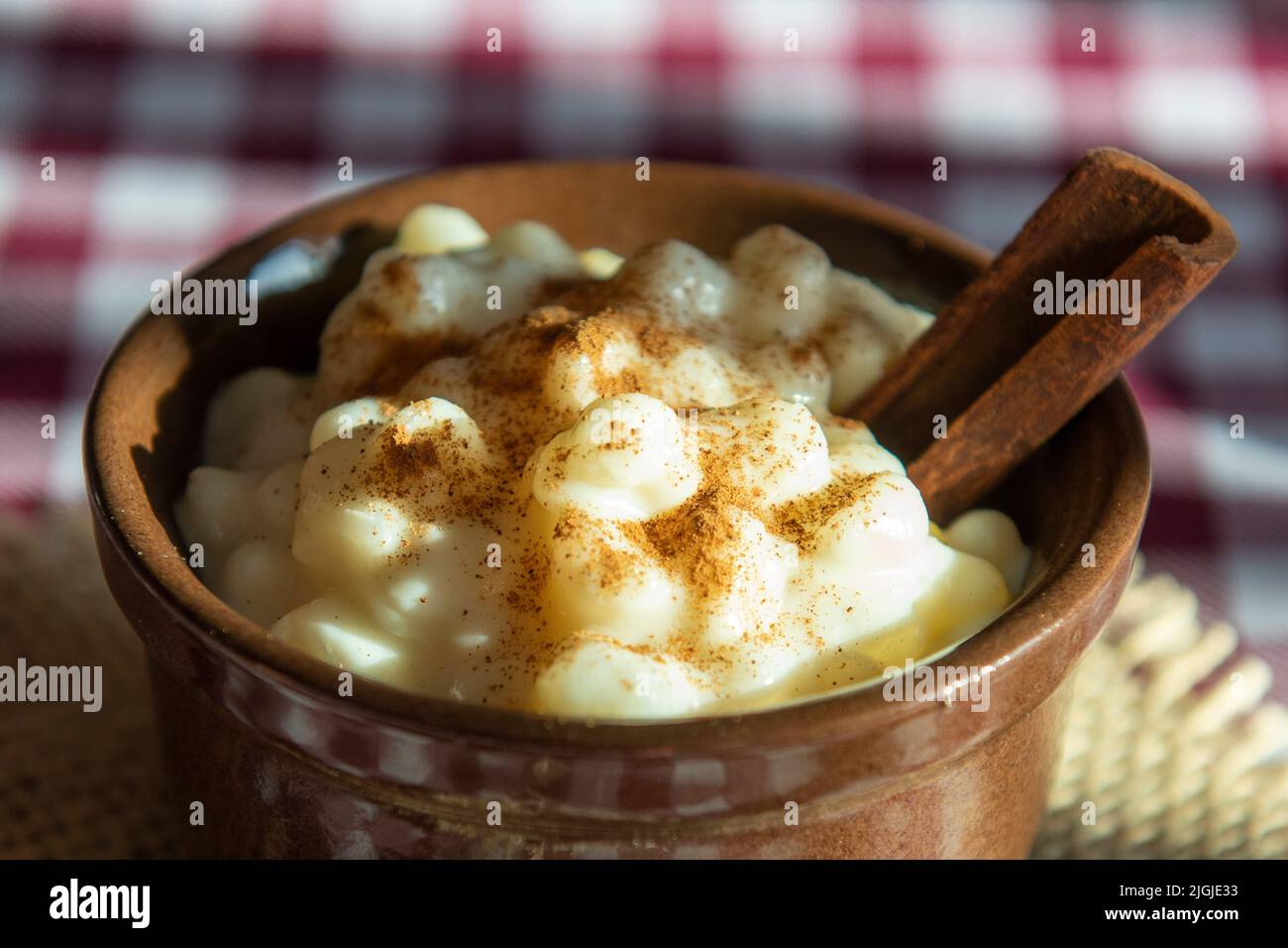 Brazilian sweet dessert, Canjica. White corn porridge with cinnamon and ...