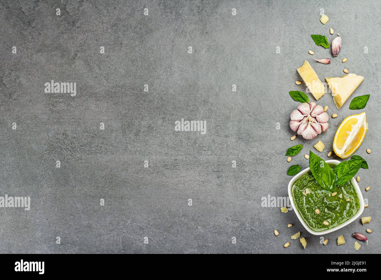 Pesto sauce in a bowls with pine nuts, parmesan and garlic. Traditional ...