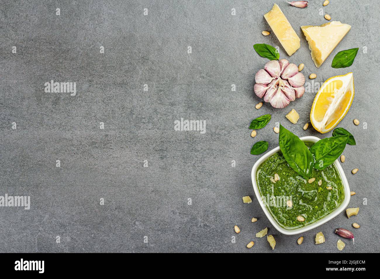 Pesto sauce in a bowls with pine nuts, parmesan and garlic. Traditional ...