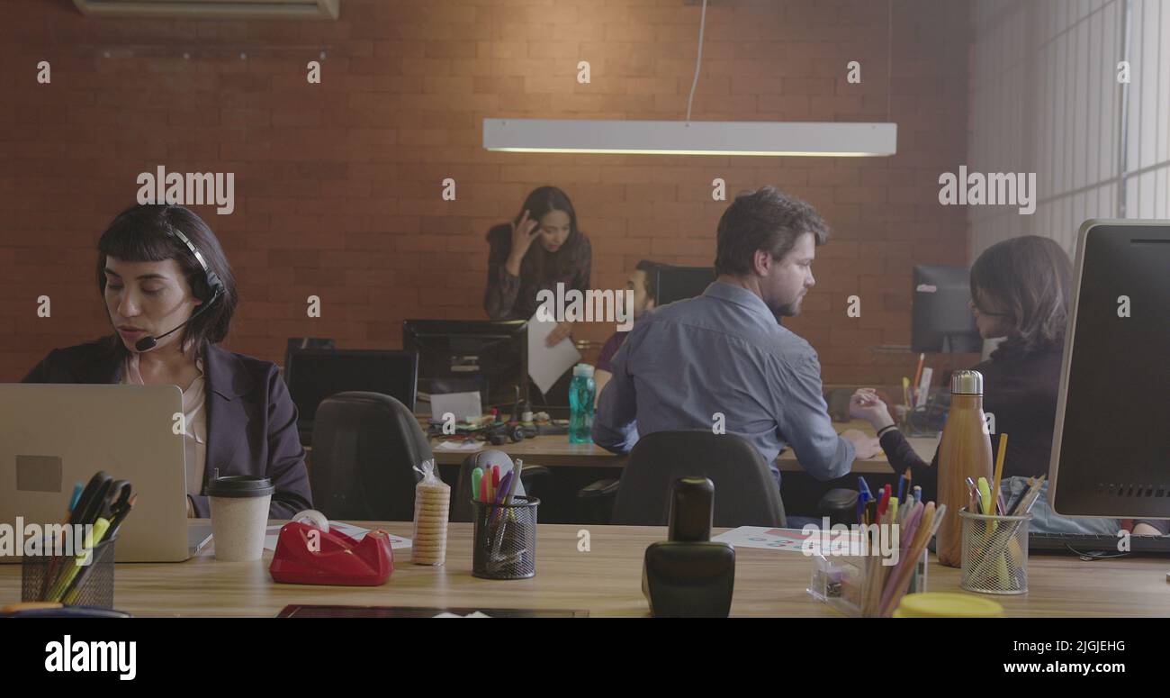 Group of young business people working at the office. Employees startup ...