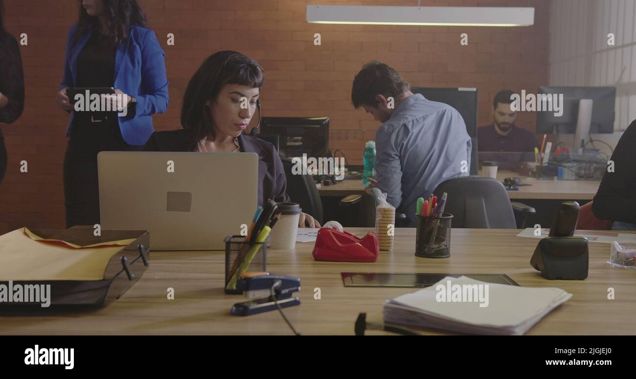 Group of young business people working at the office. Employees startup ...