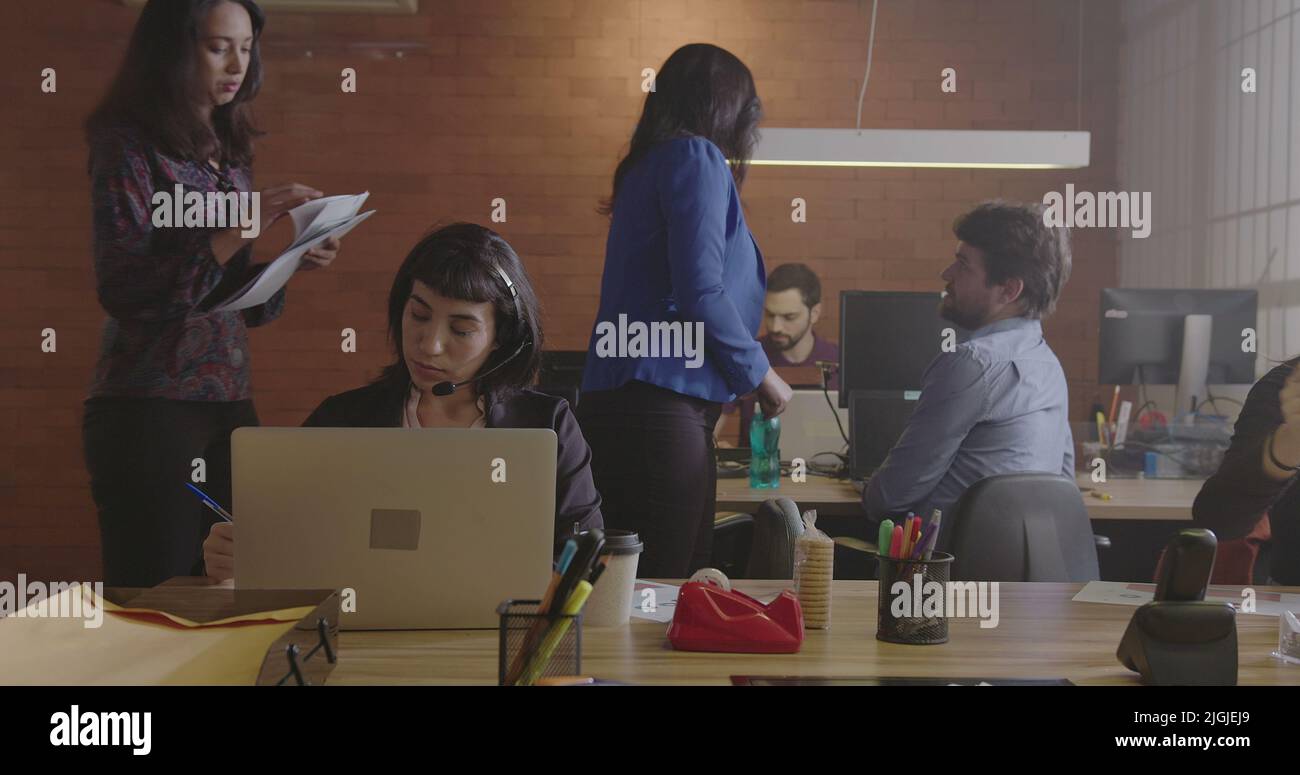 Group of young business people working at the office. Employees startup ...