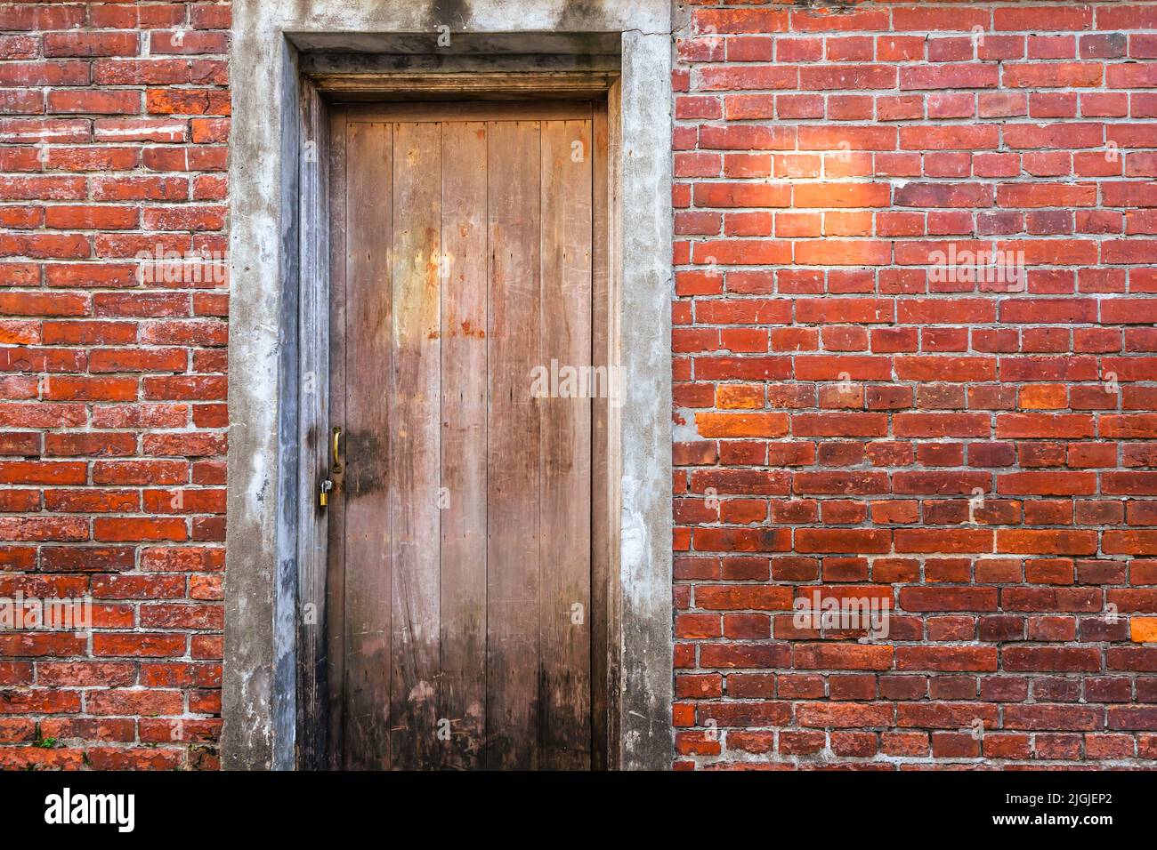 A old locking wooden door with the red brick wall.(Bopiliao history ...