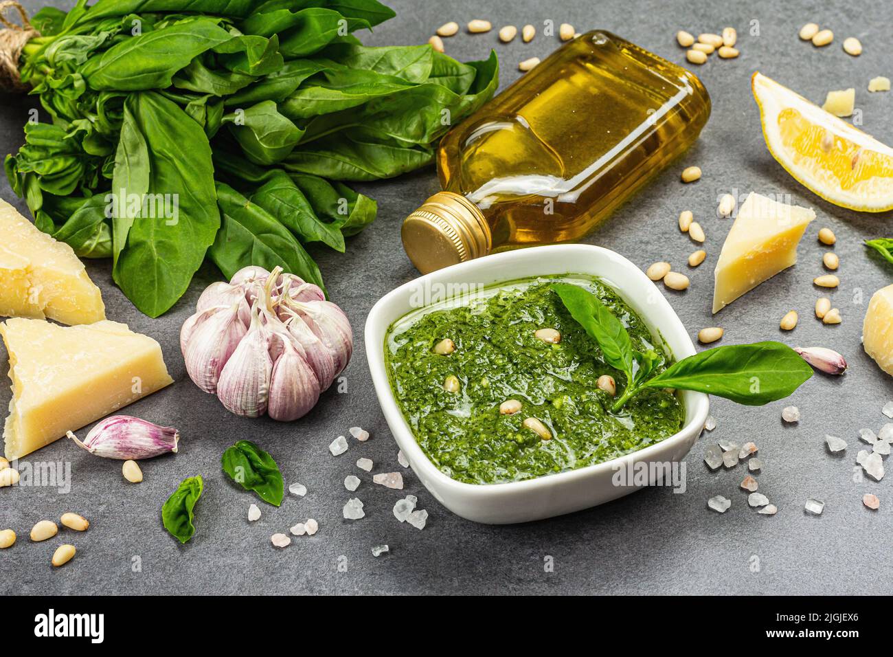 Pesto sauce in a bowls with pine nuts, parmesan and garlic. Traditional ...