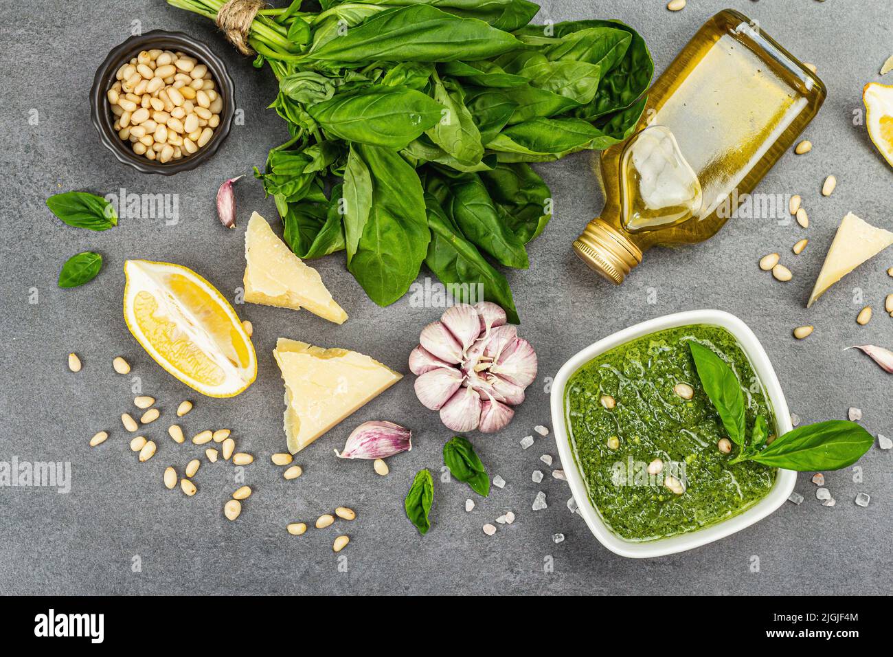 Pesto sauce in a bowls with pine nuts, parmesan and garlic. Traditional ...