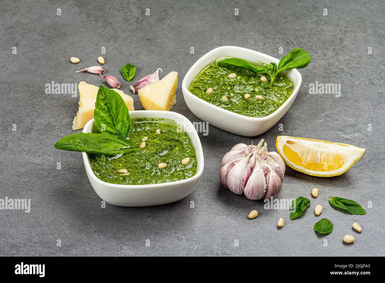 Pesto sauce in a bowls with pine nuts, parmesan and garlic. Traditional ...