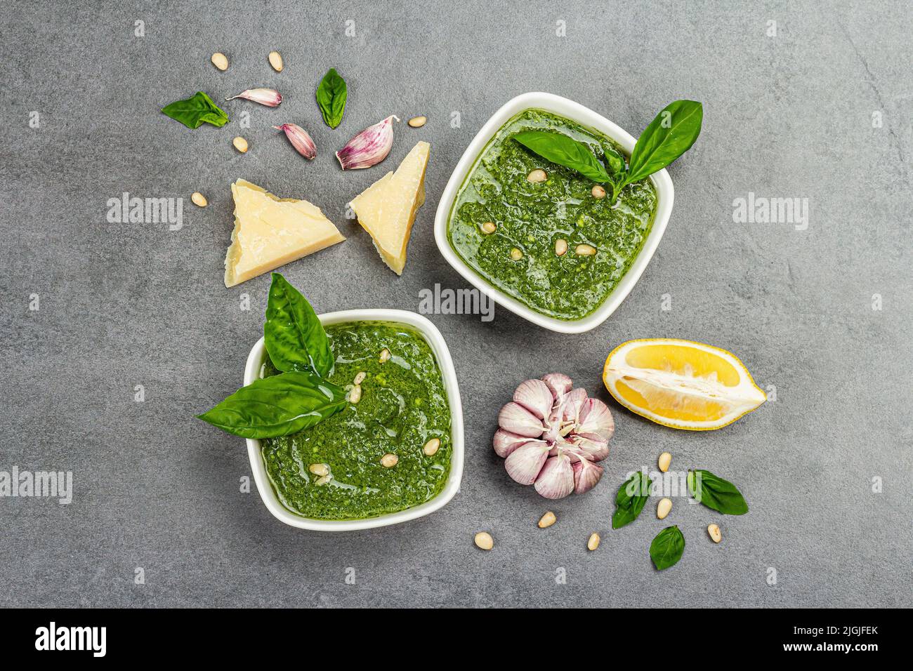 Pesto sauce in a bowls with pine nuts, parmesan and garlic. Traditional ...