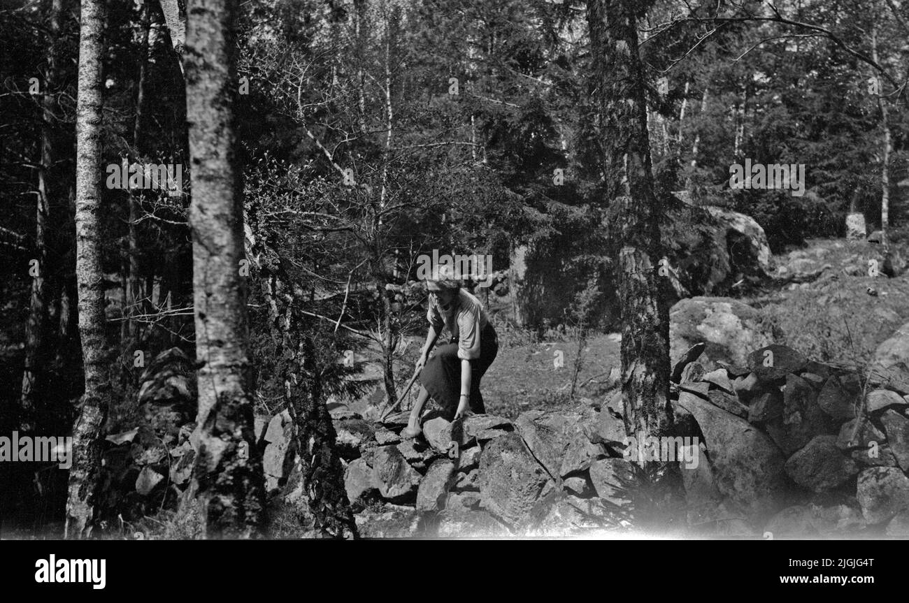 Woman steps over a stone wall, unknown place Stock Photo - Alamy