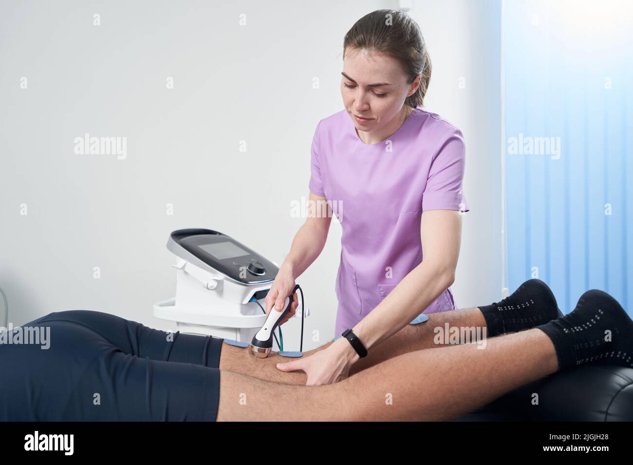 Female doctor performing ultrasound therapy procedure in clinic Stock ...