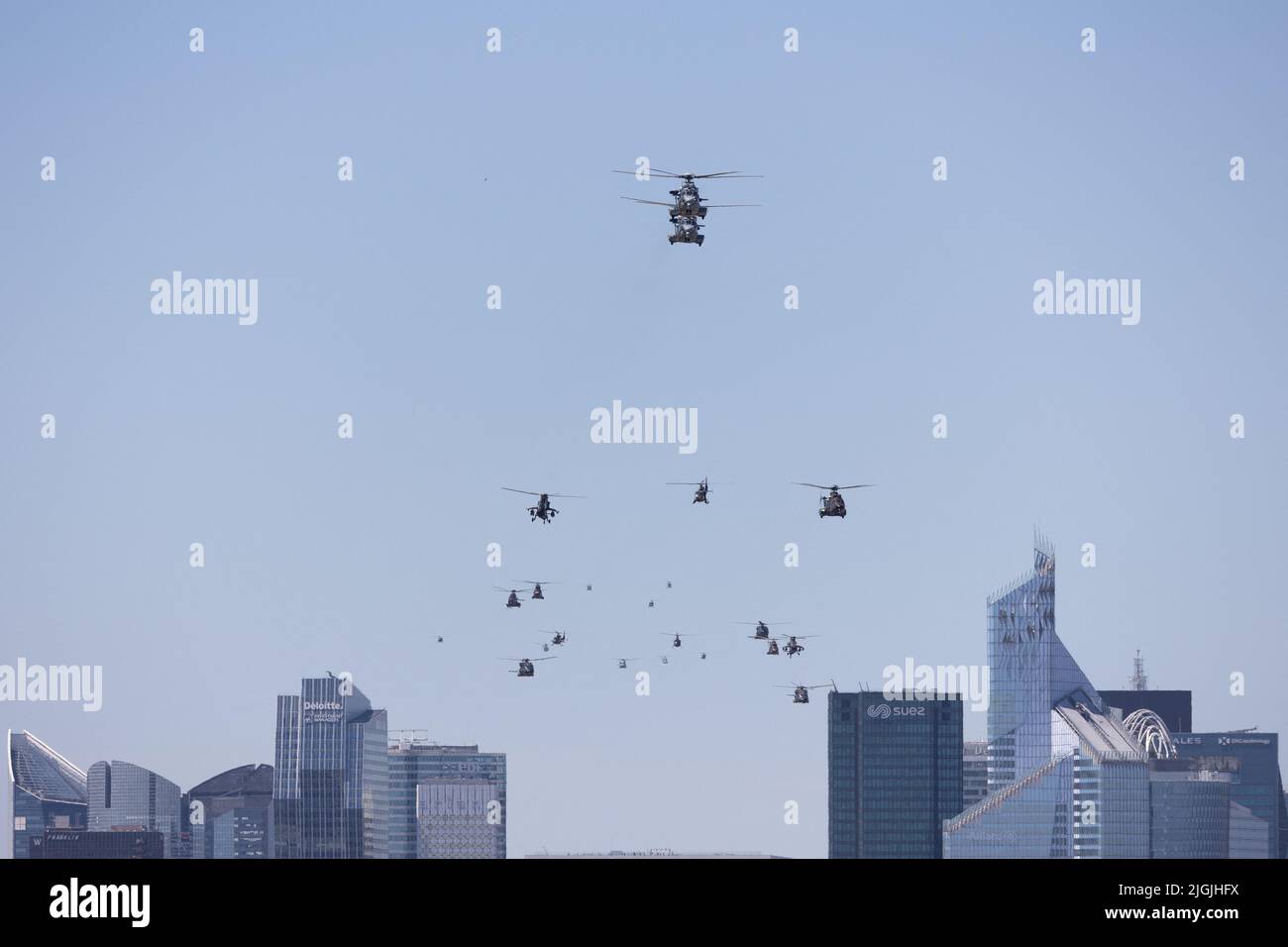 Helicopters fly over La Defense business district during a aerial ...