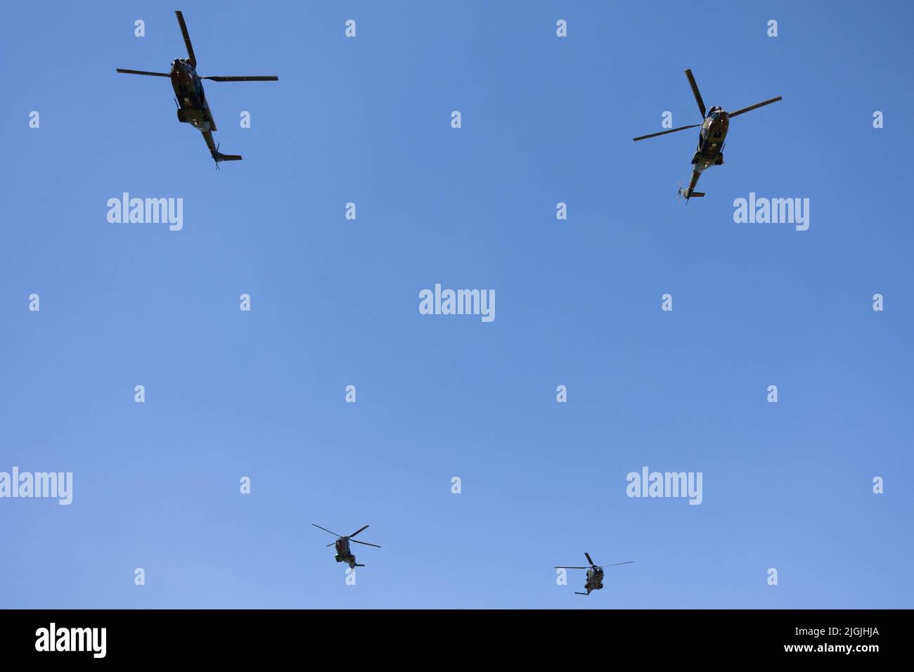 Helicopters fly over La Defense business district during a aerial ...