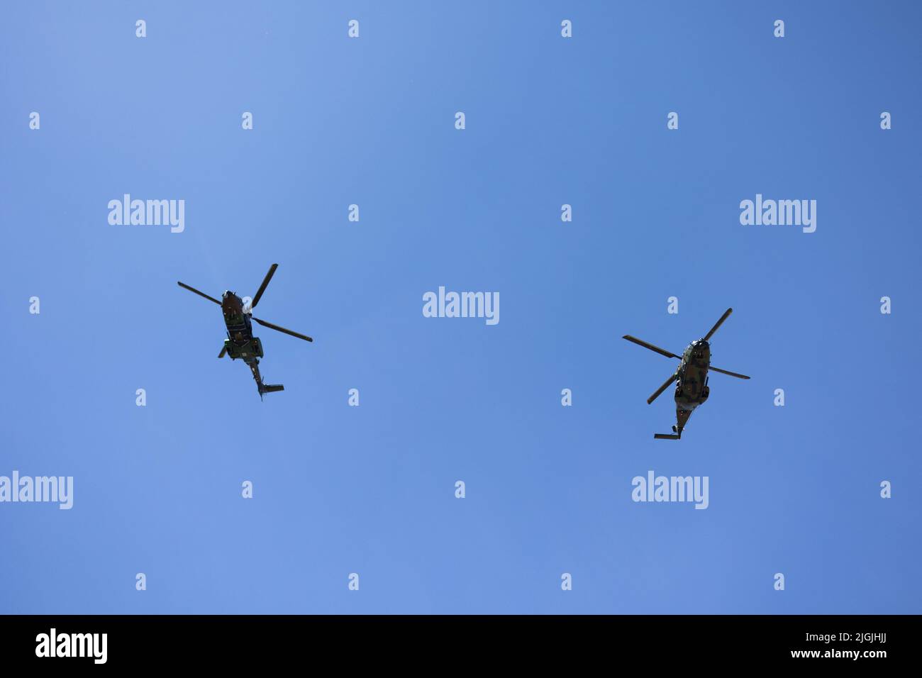 Helicopters fly over La Defense business district during a aerial ...