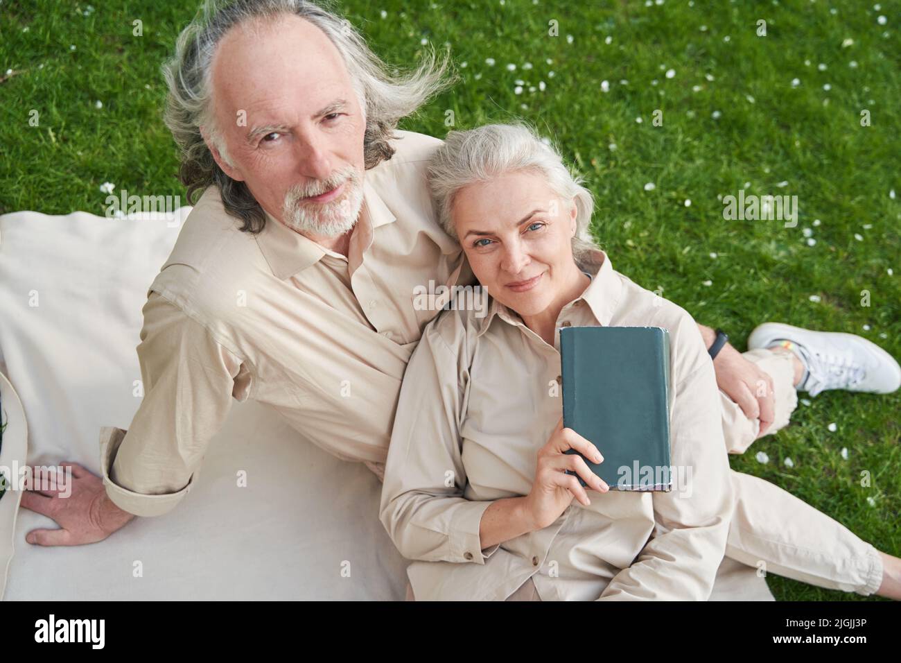 Two happy people having rest on the grass Stock Photo - Alamy