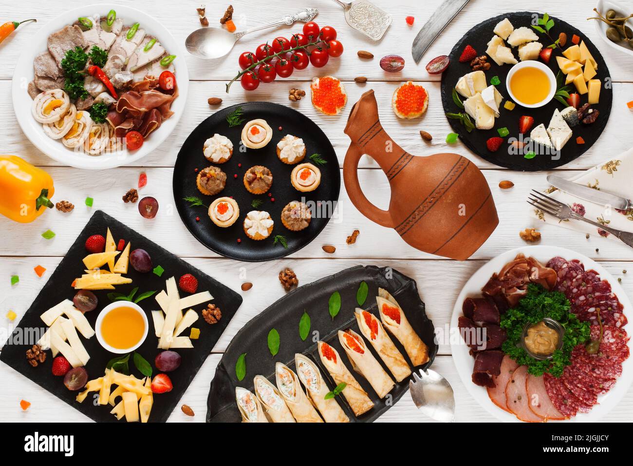 Tasty snacks variety with clay jug, flat lay Stock Photo - Alamy