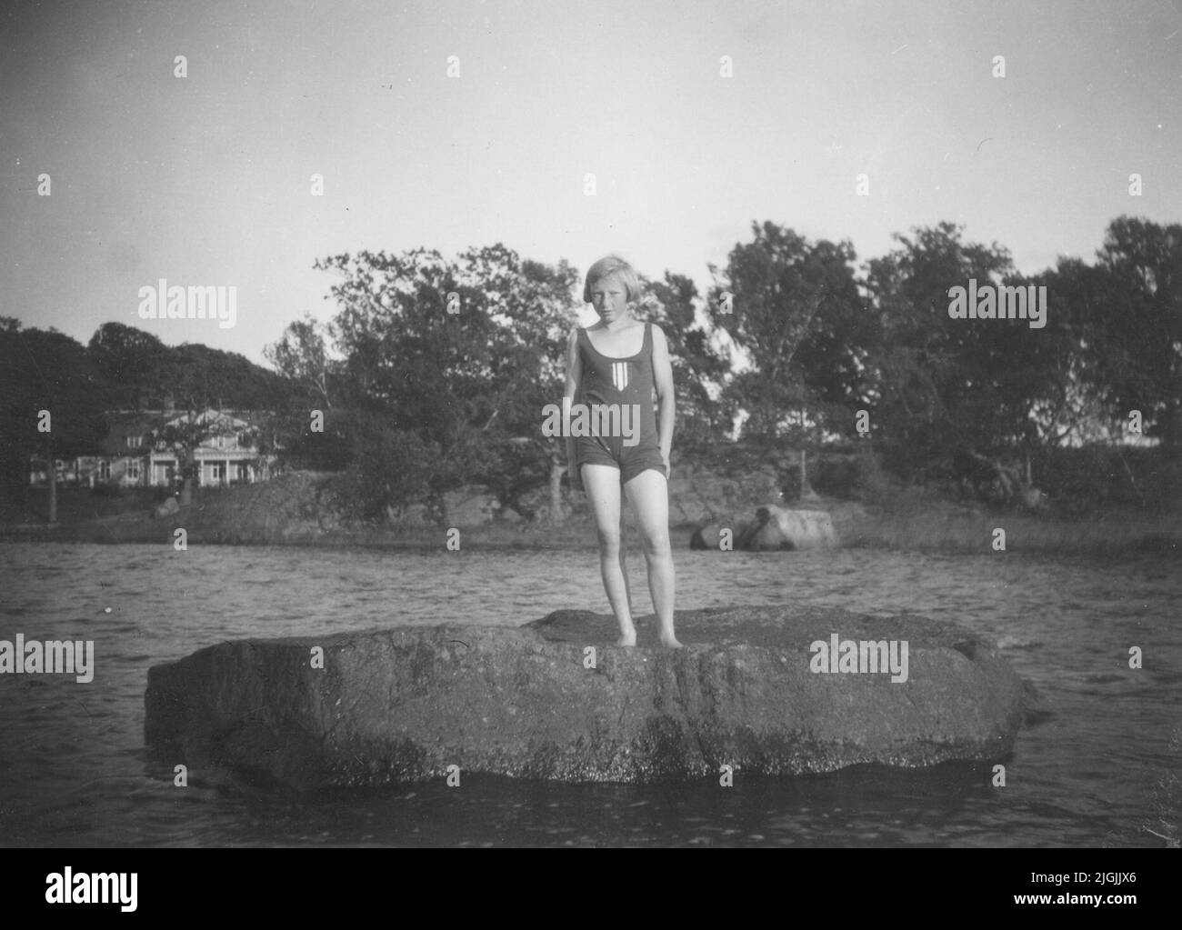 Flicka Girl in swimsuit on a cliff in Verkö Sund outside Verkö Herrgård ...