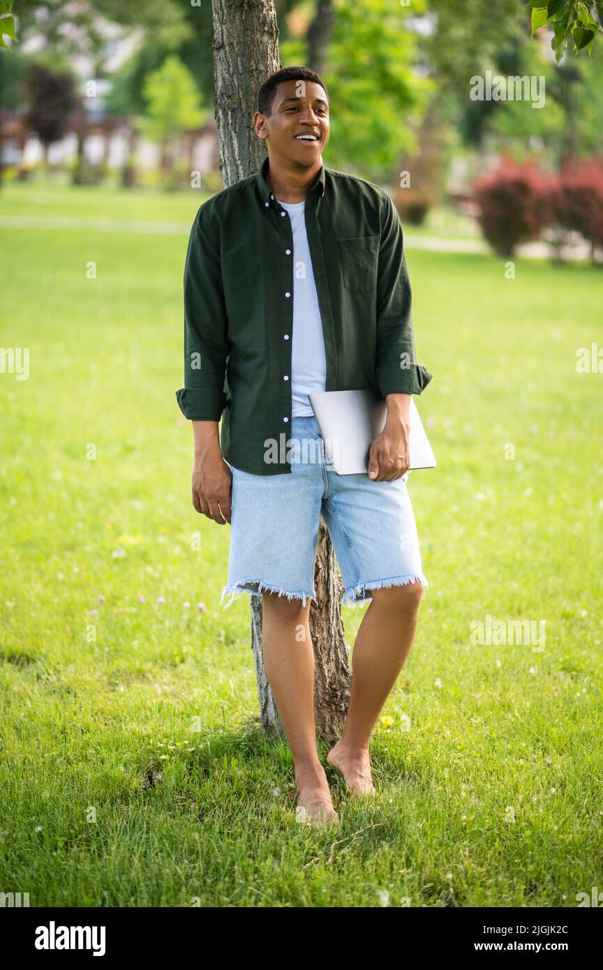 Man standing near tree hi-res stock photography and images - Alamy