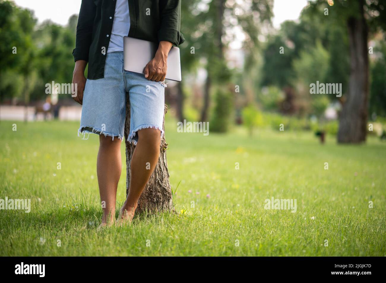Man standing near tree hi-res stock photography and images - Alamy