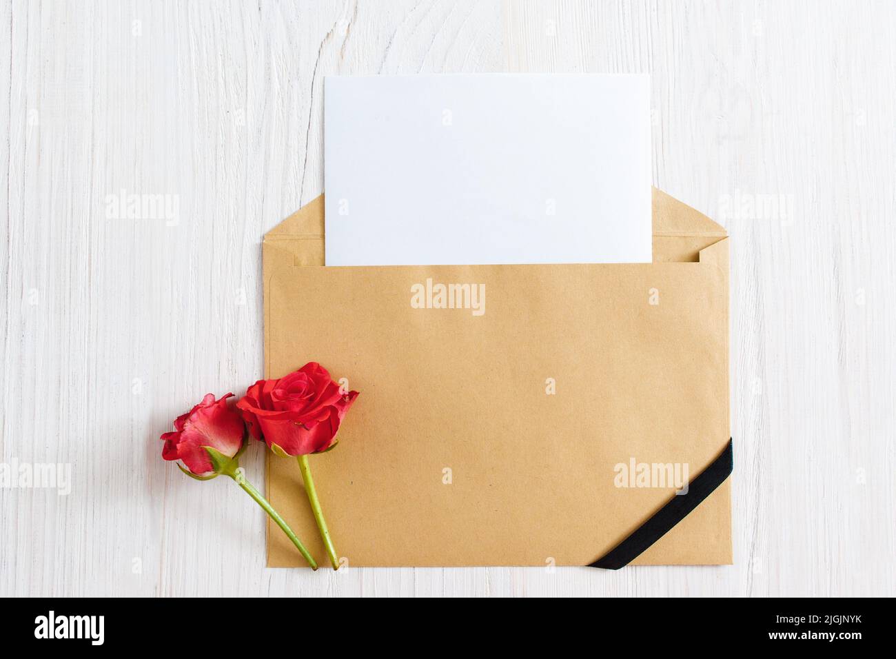 Opened envelope with blank paper and black ribbon Stock Photo - Alamy