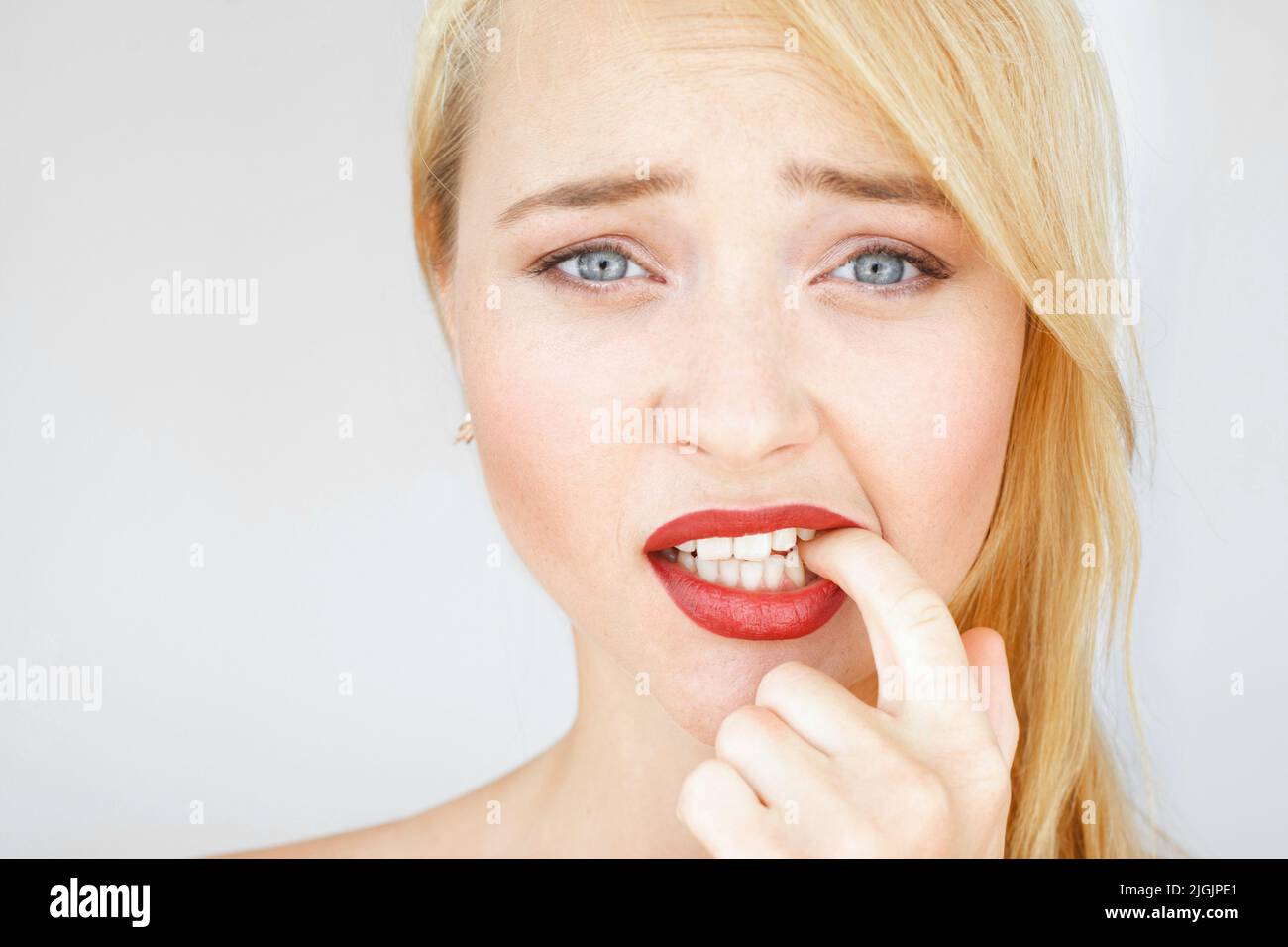 Beautiful red woman with confused look portrait Stock Photo - Alamy