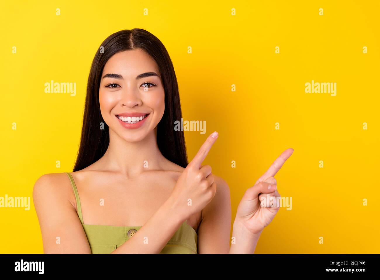 Photo of pretty cheerful filipino person indicate fingers empty space ...