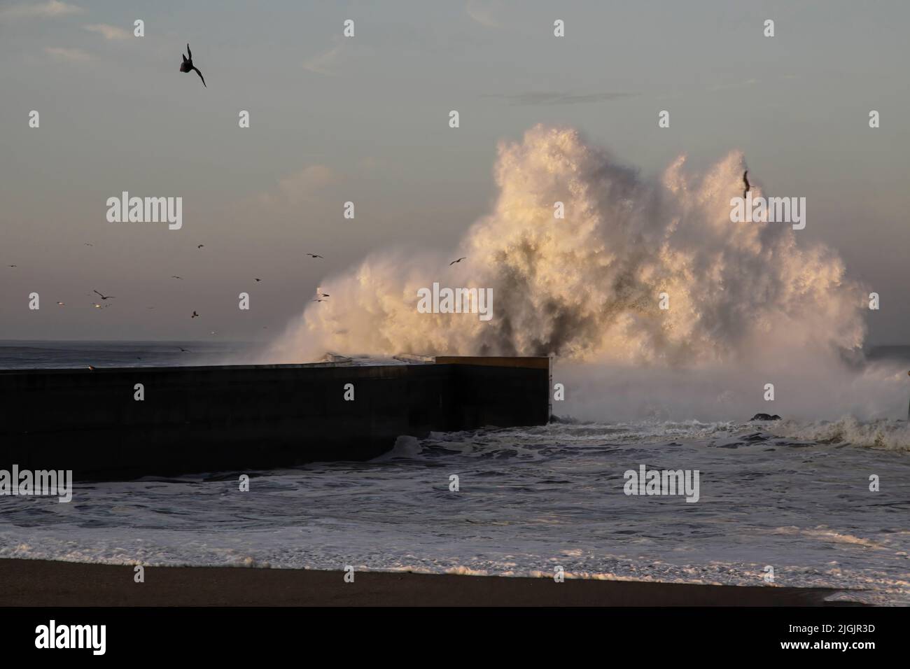 Big sea wave splash at dawn. Douro river mouth south pier, Porto ...