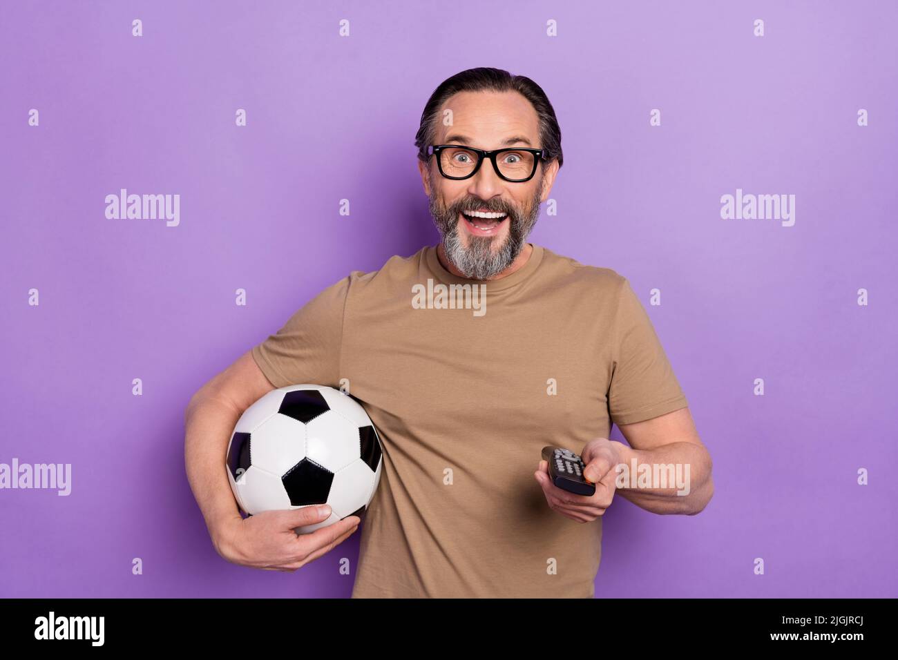 Photo of funky cheerful overjoyed big football fan watch tv world cup ...
