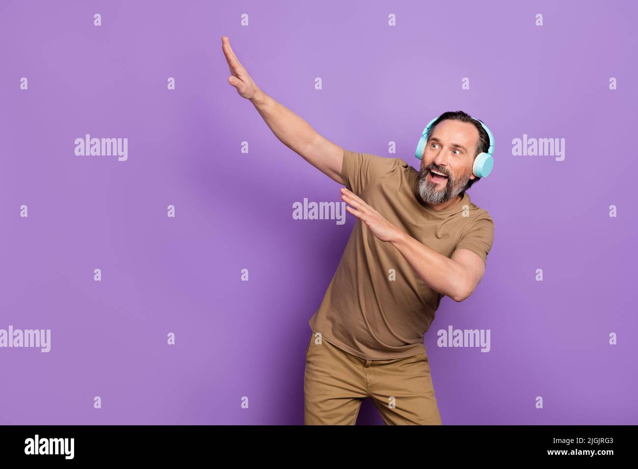 Photo of cheerful energetic middle-aged man feeling young dancing dab ...
