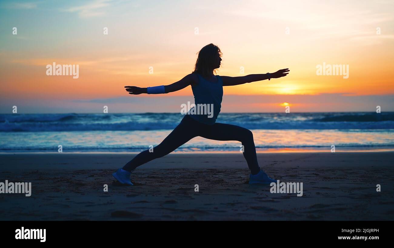 Silhouette Woman practice yoga warrior pose to meditation with summer ...