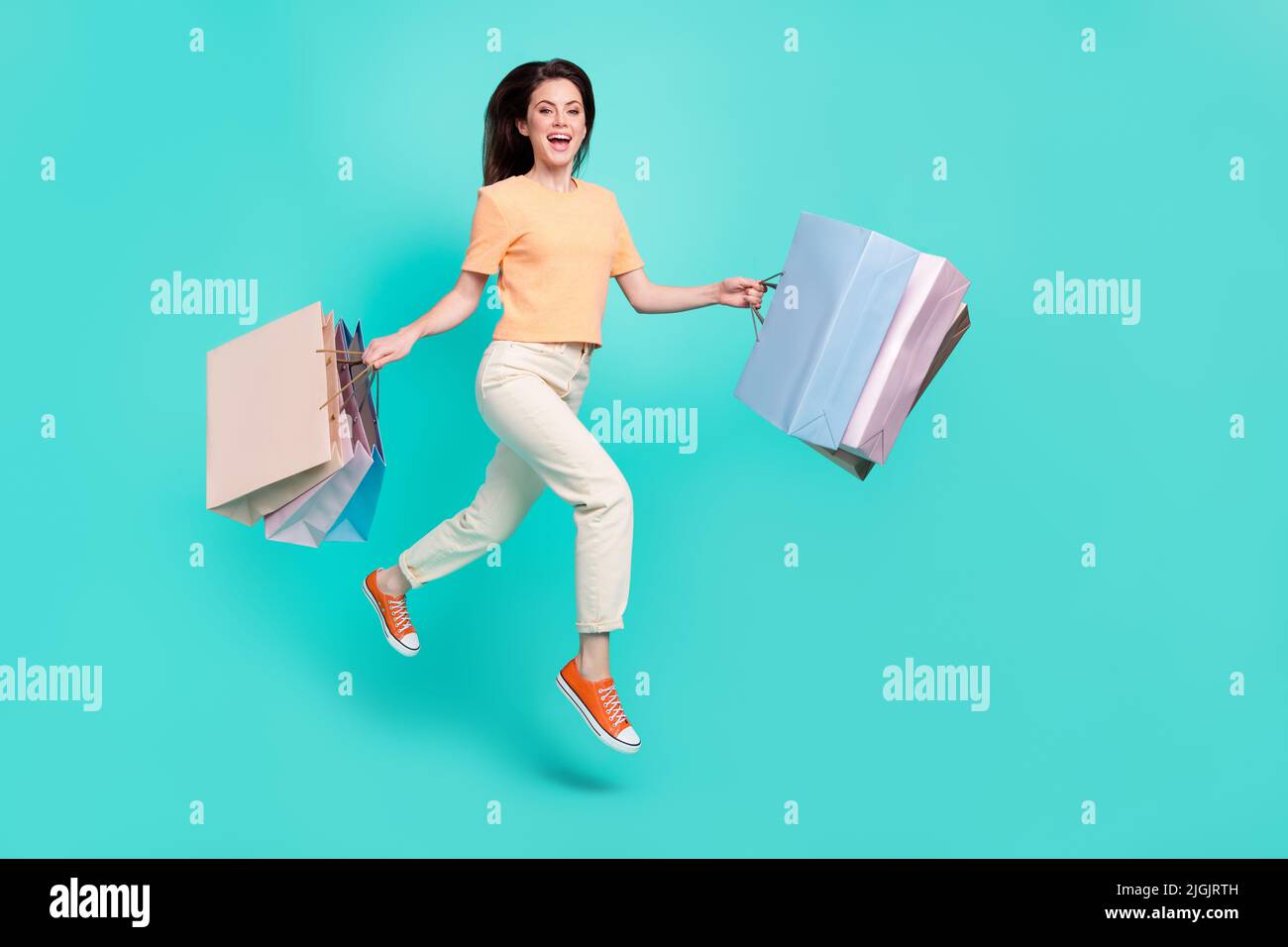 Full body profile photo of attractive overjoyed lady run jump hold ...