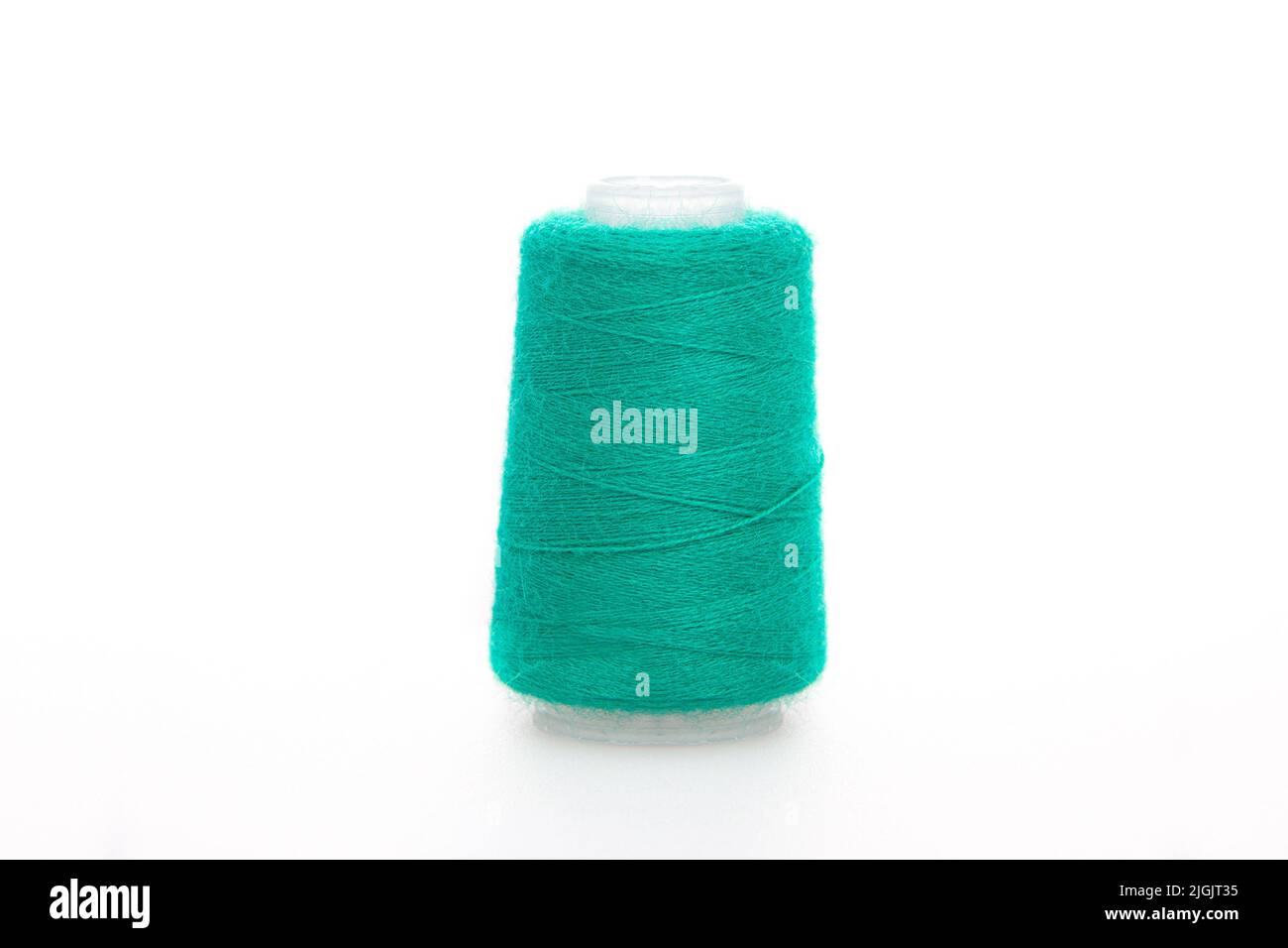Green spool of thread isolated on white background. Skein of woolen ...