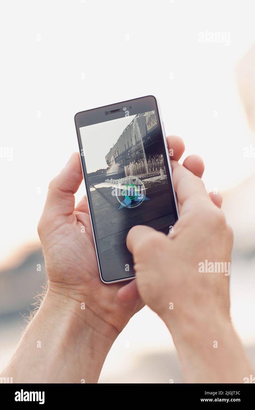 Pokemon Go playing smartphone game. Addicted Stock Photo - Alamy